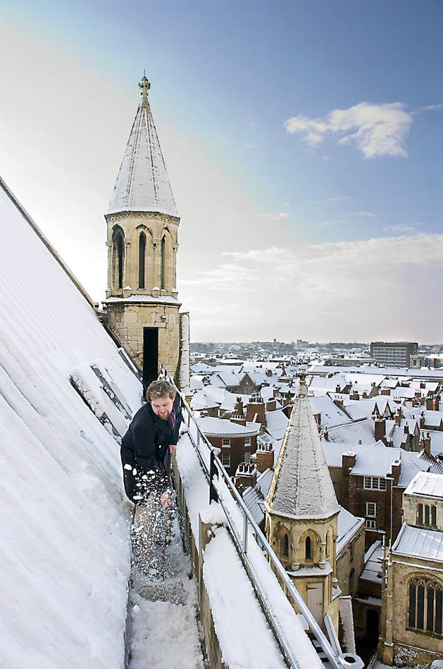 Snow being swept from the rooftops of the York Minster